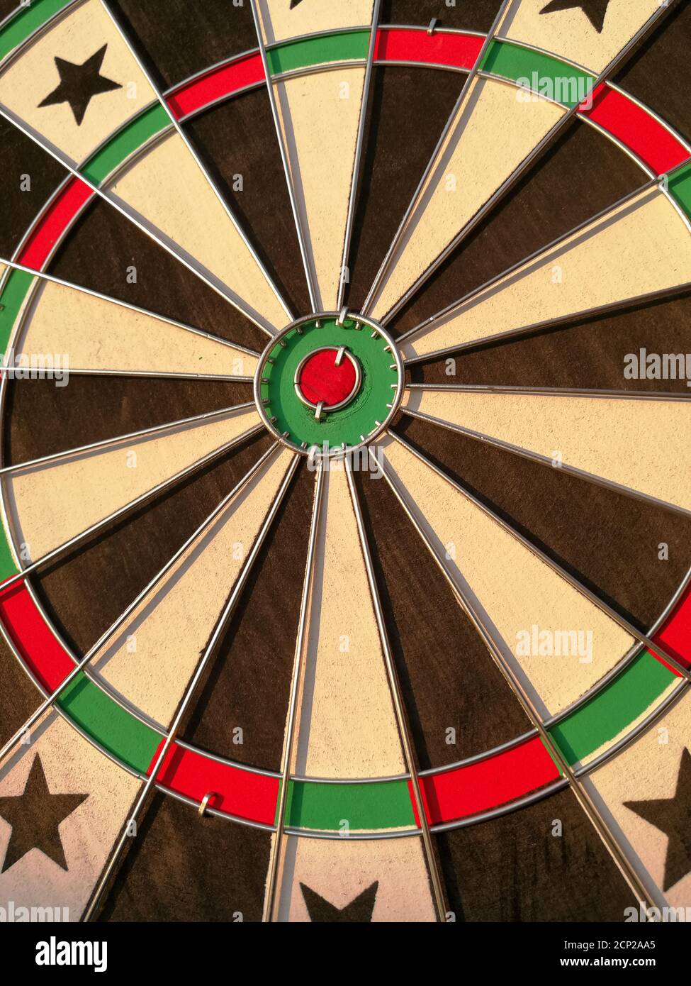 Dart wooden target hanged on the wall ready to play. Leisure activity ...