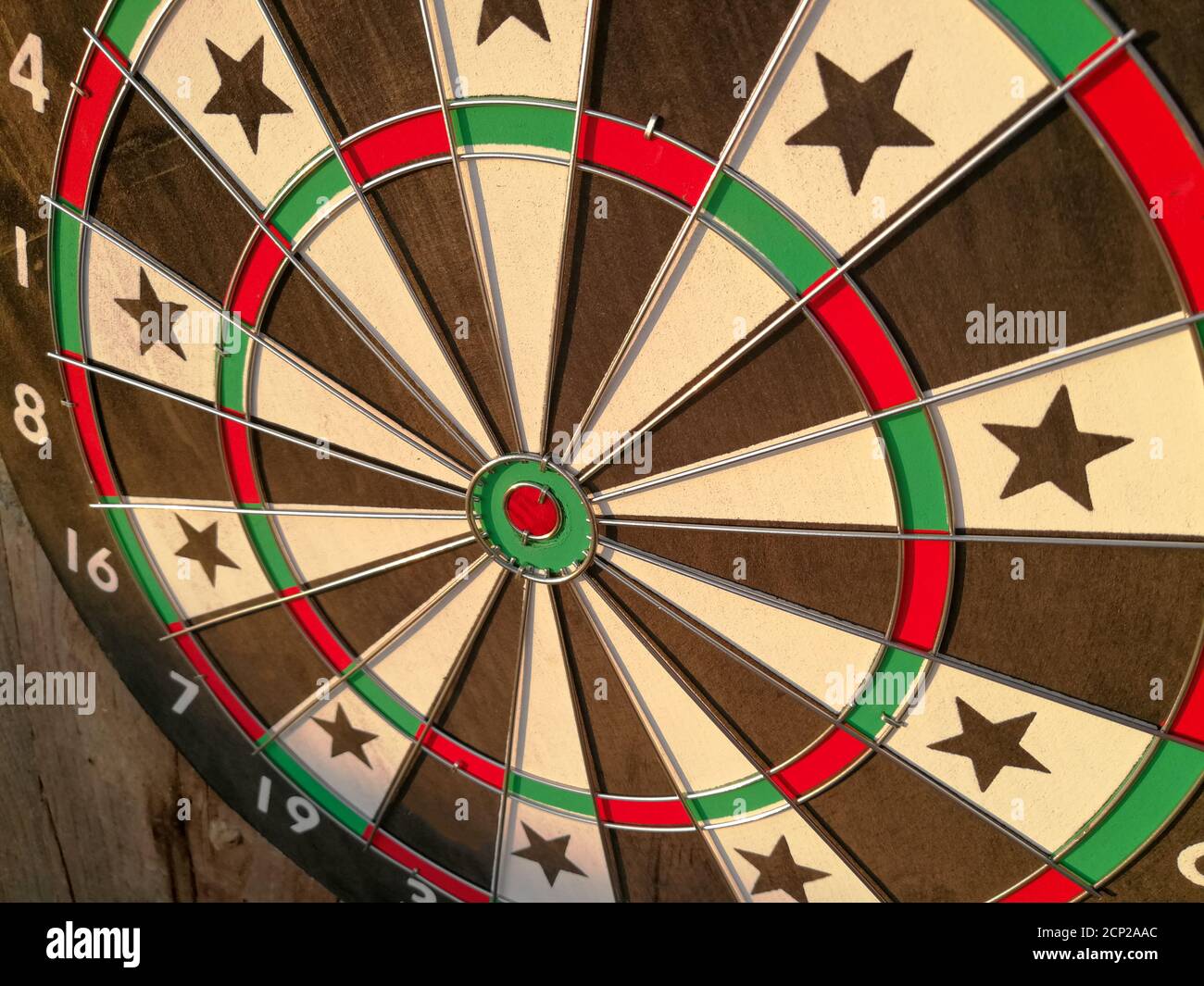 Dart wooden target hanged on the wall ready to play. Leisure activity ...