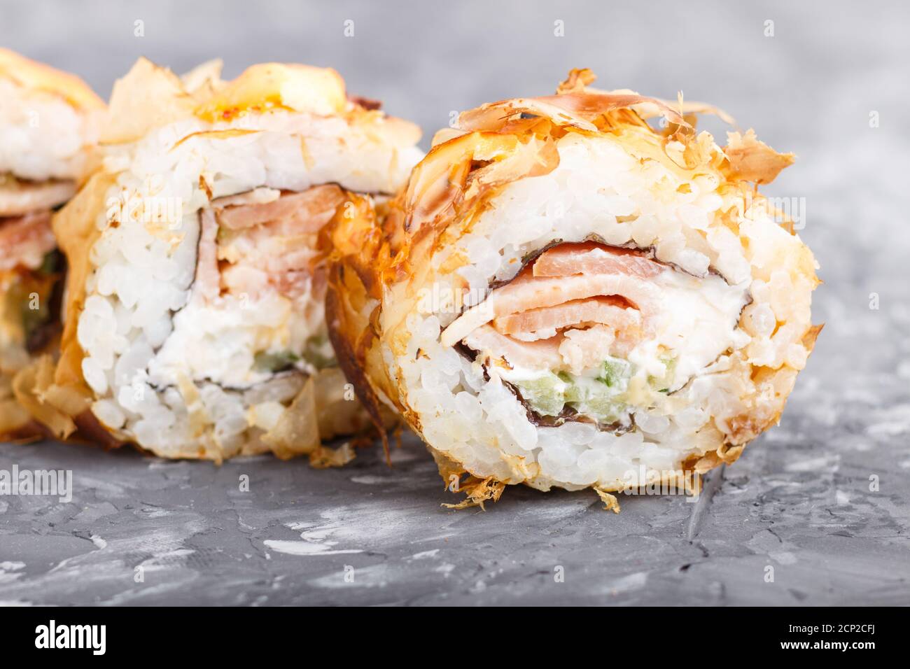 Japanese maki sushi rolls with tuna, cucumber, cheese on black concrete ...