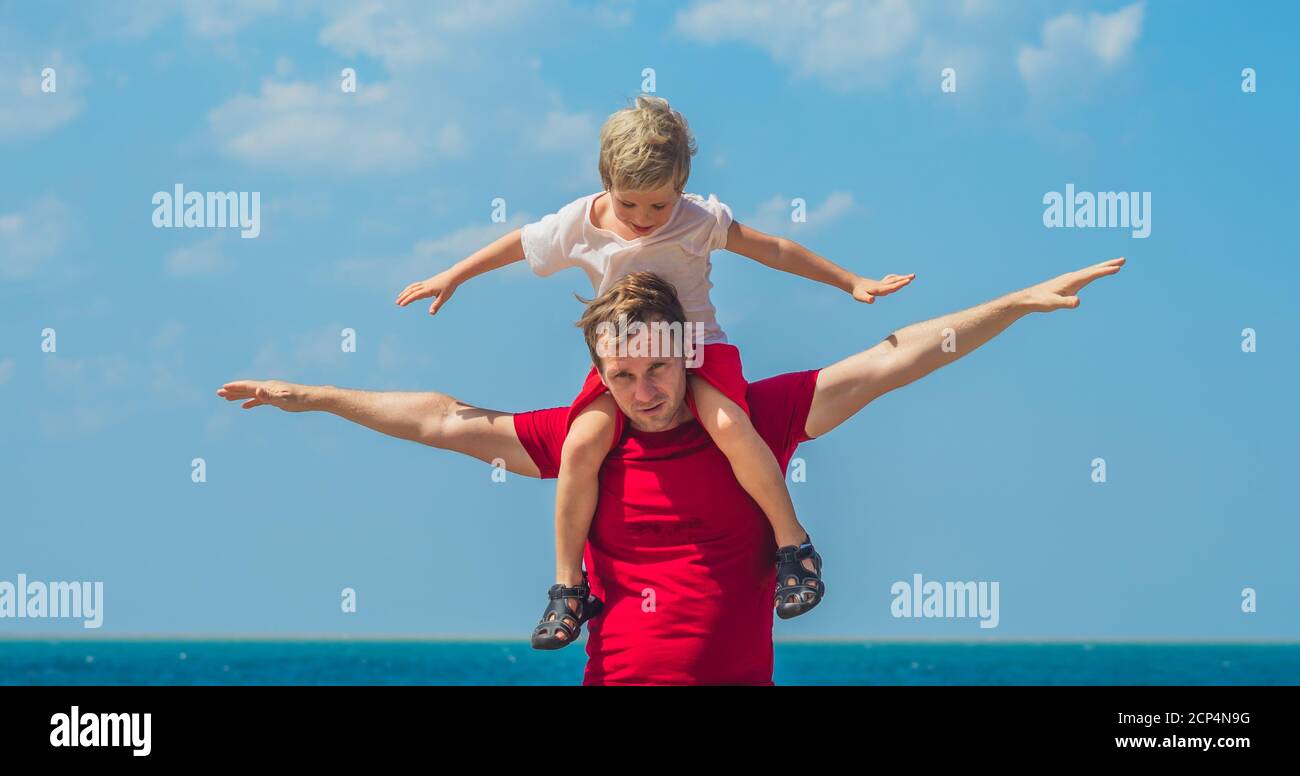 Happy smile father hugs holds on shoulders son boy male child stand ...