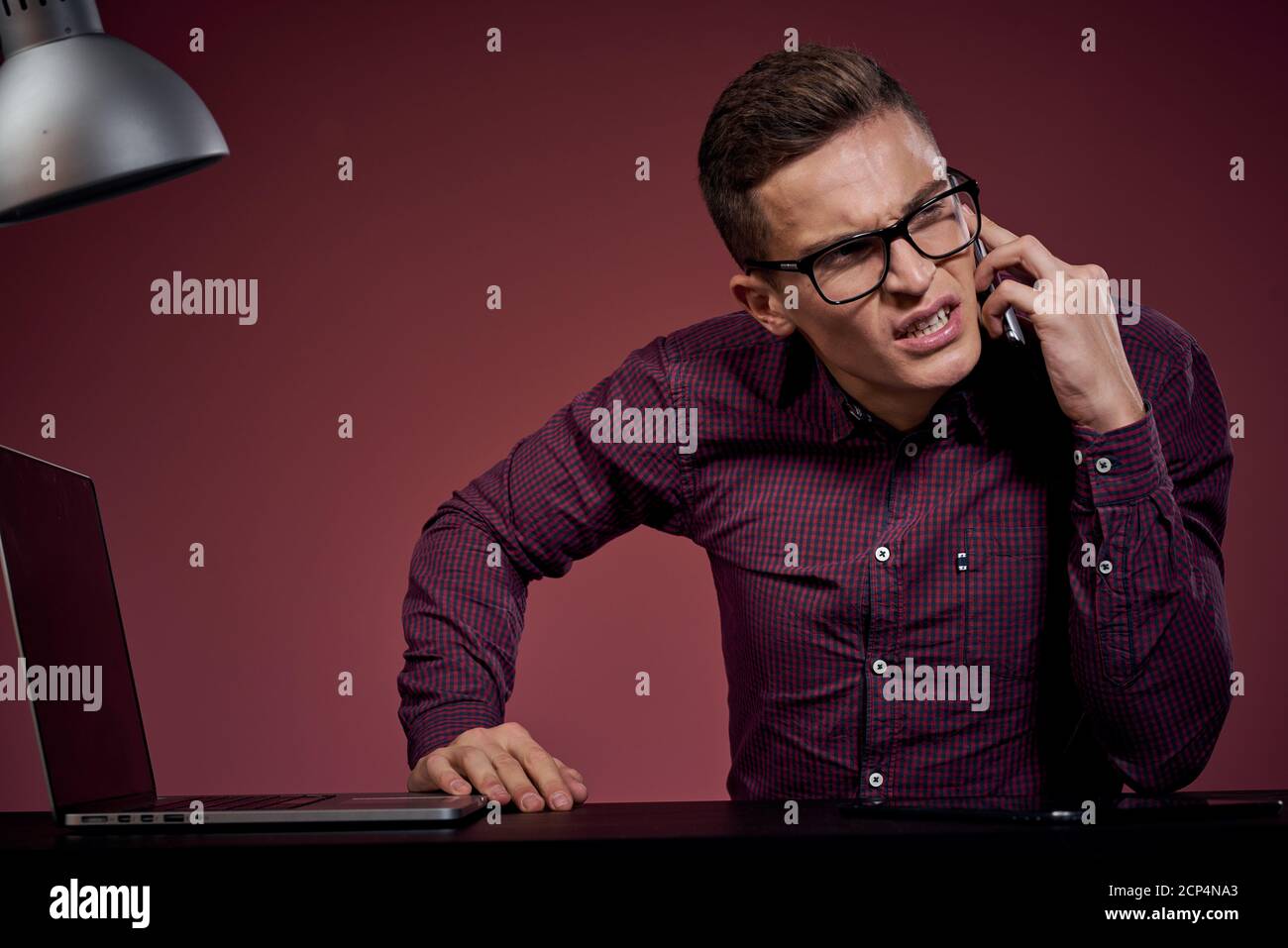 Business man in office and talking on the phone manager red background ...