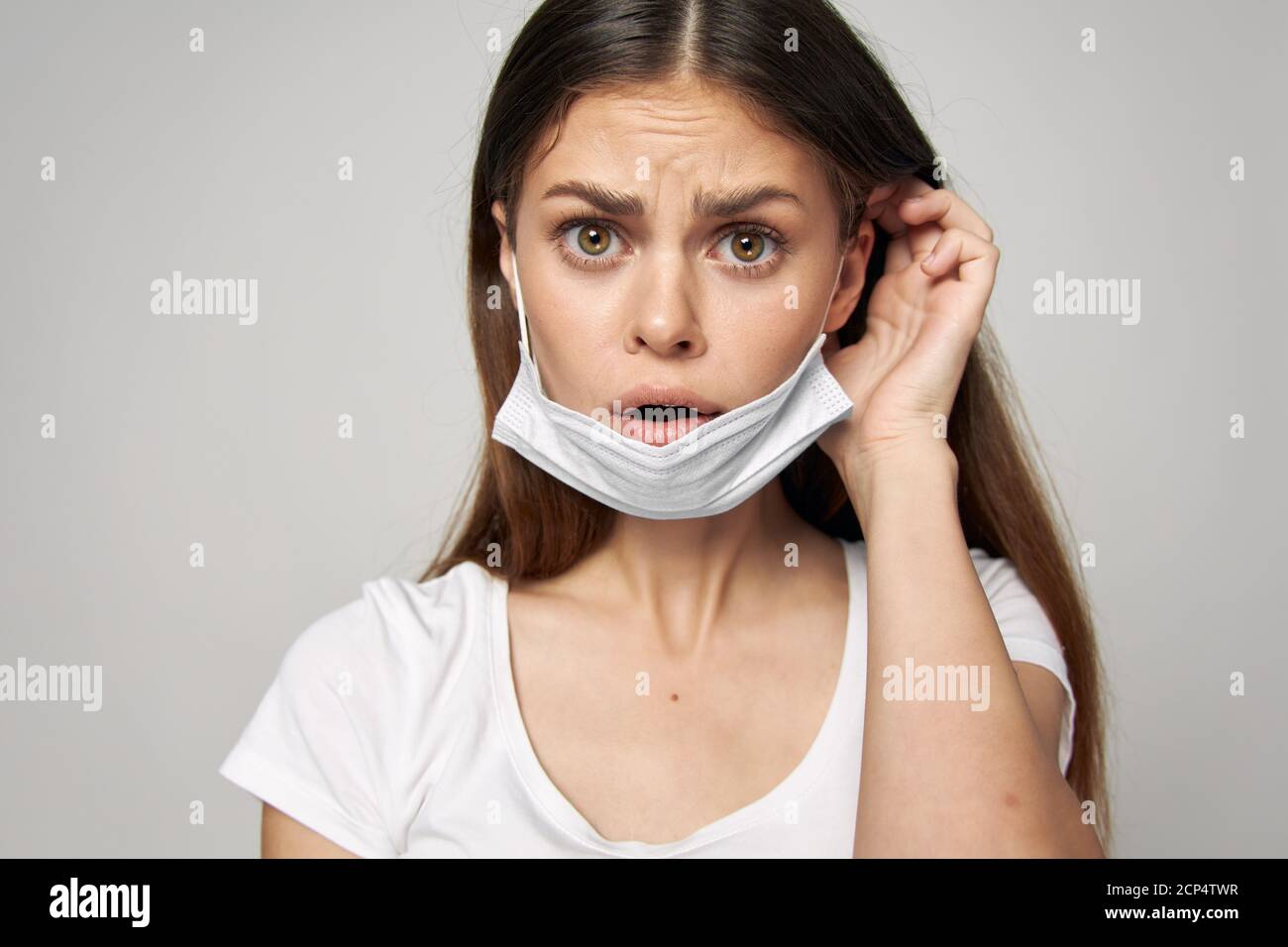 Woman with medical mask on her face displeased look emotions close-up ...