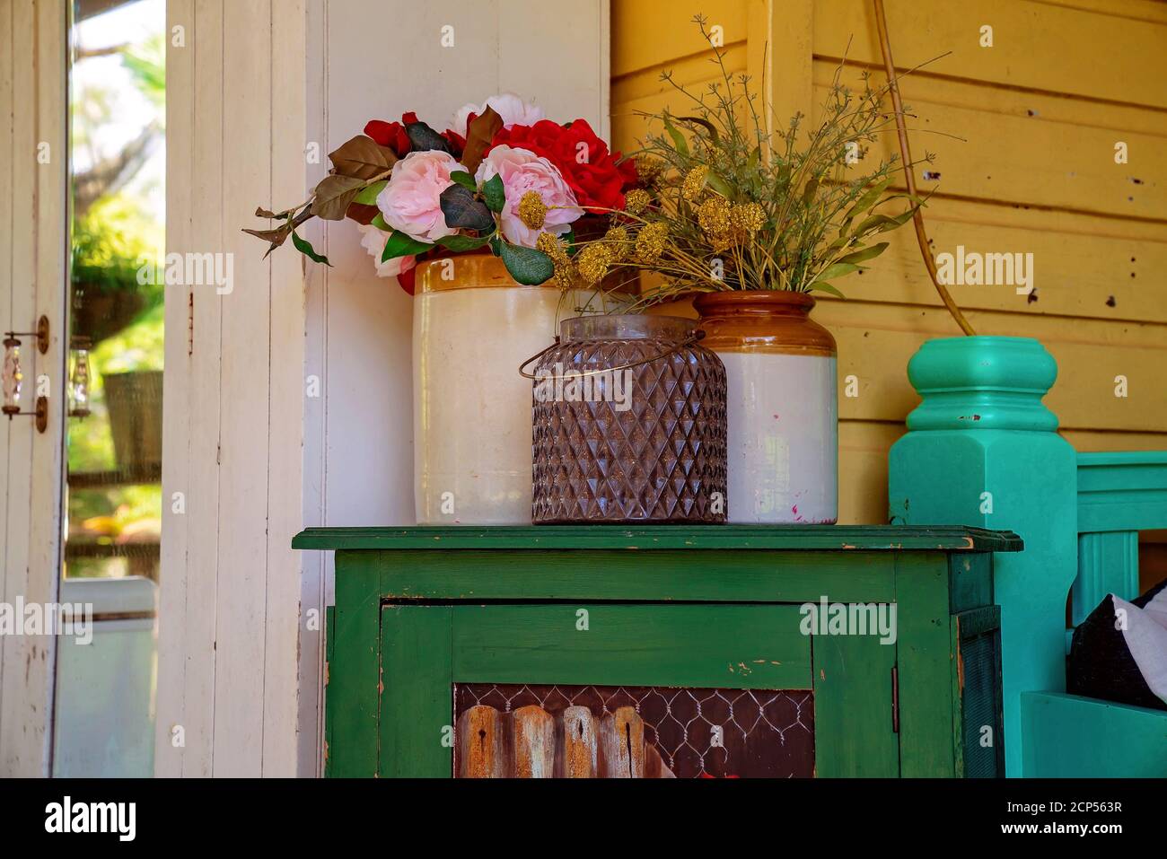 A collection of old fashioned jars and flowers placed on a vintage ...