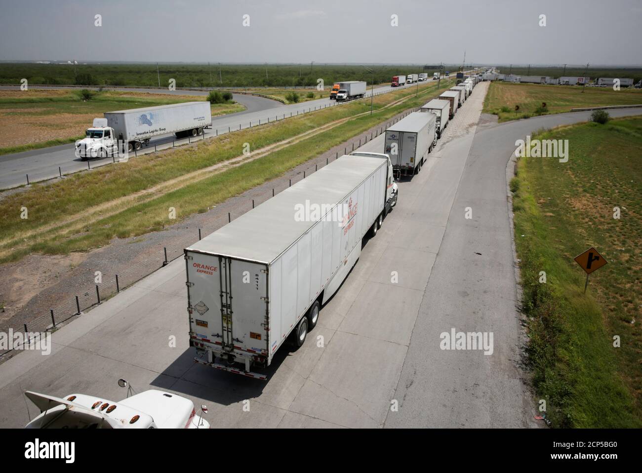Trucks wait in a long queue for border customs control to cross into ...
