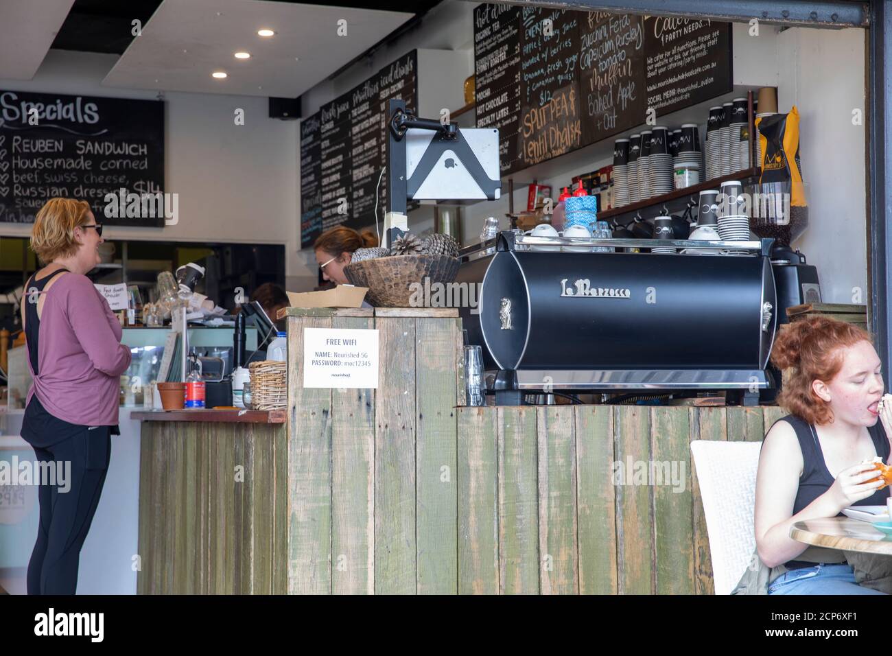 Australian cafe, lady ordering food and coffee drinks from a Sydney ...