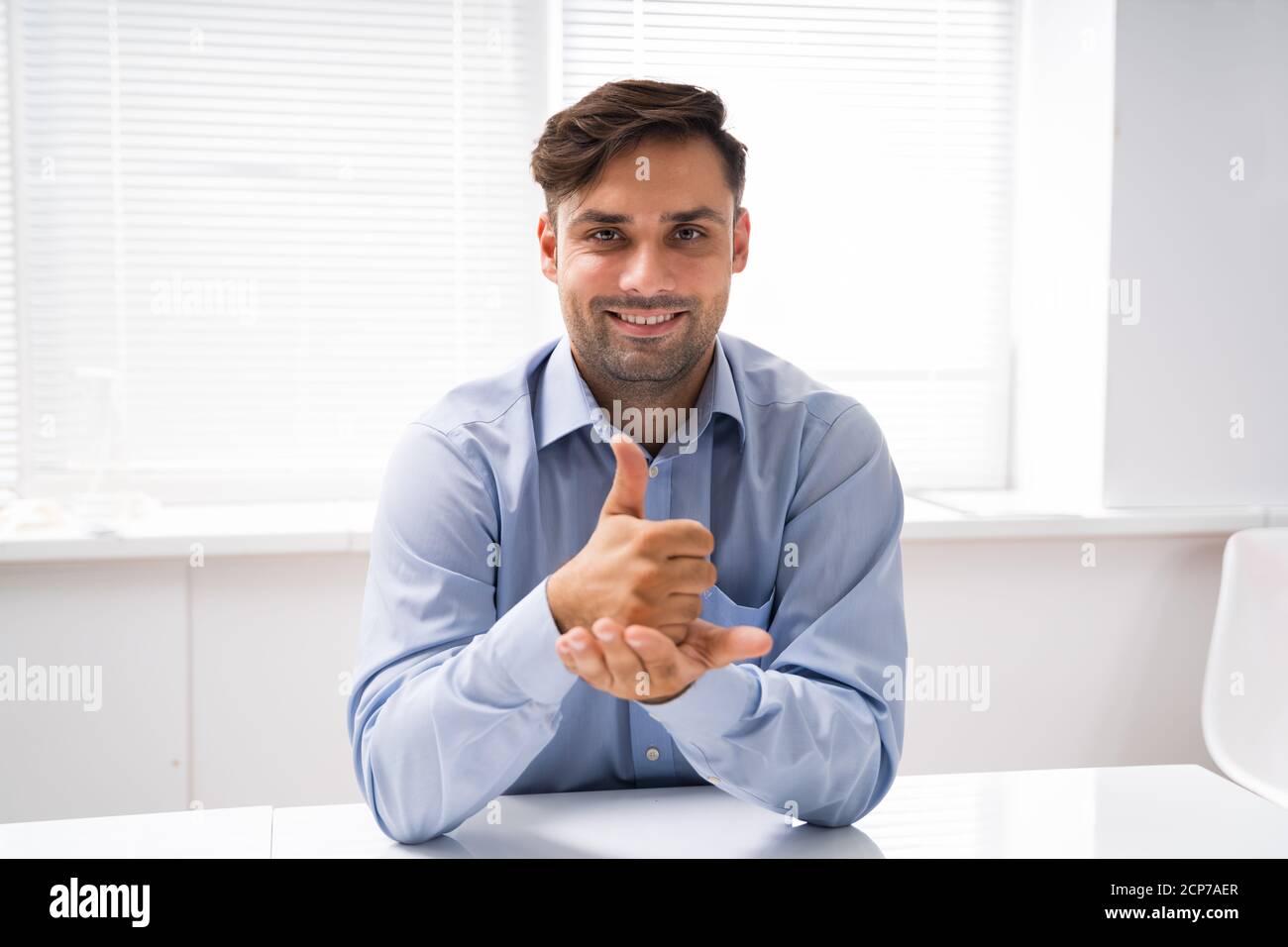 Adult Learning Sign Language For Deaf Disabled Stock Photo - Alamy