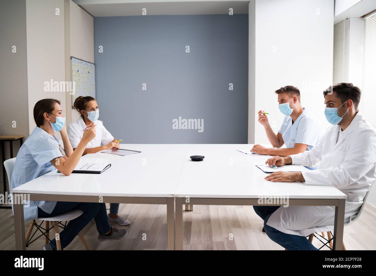 Medical Doctor Students At Desk Learning With Face Masks Stock Photo ...