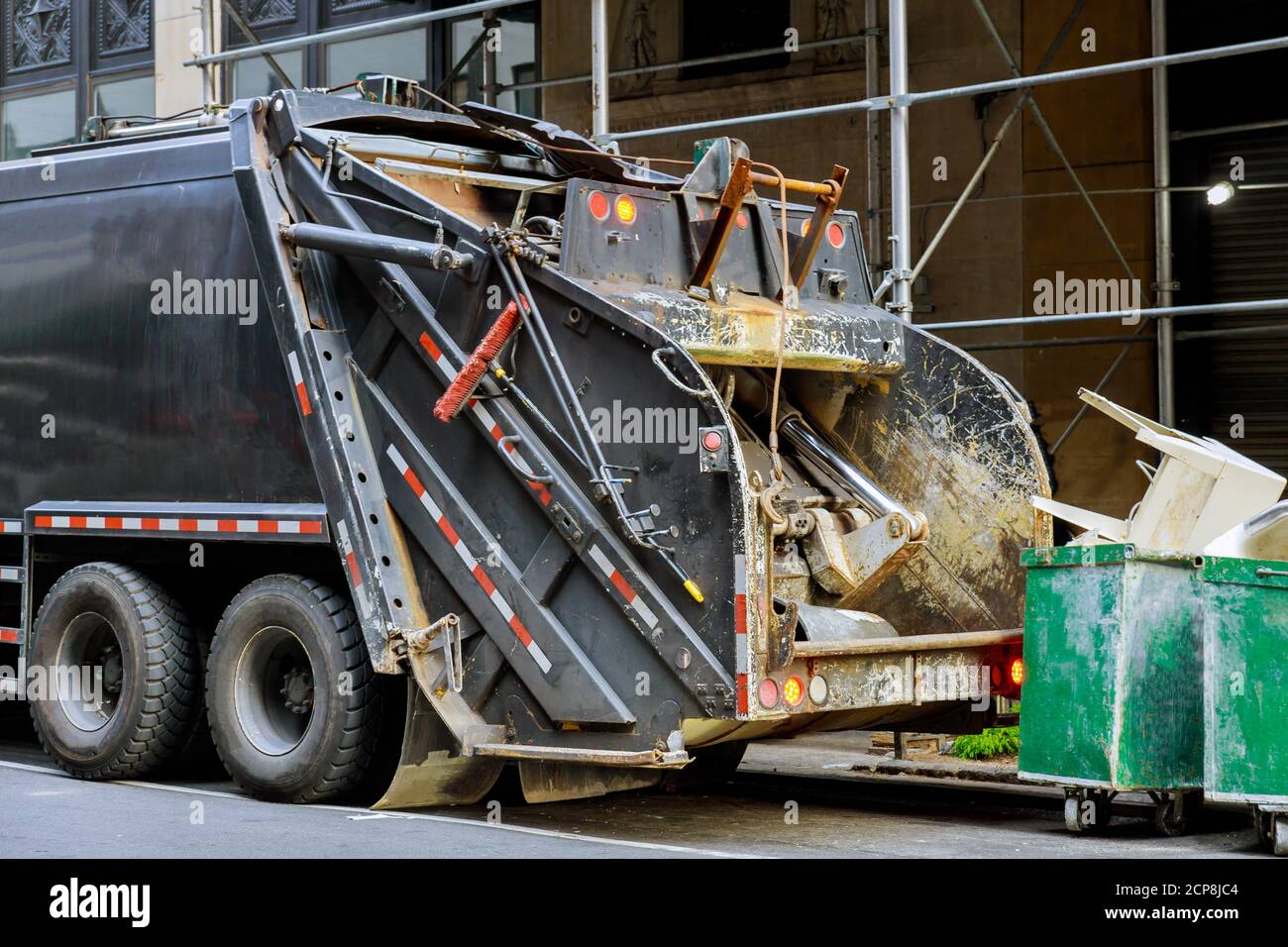City building demolition cleanup with dumpsters filled to the top ...