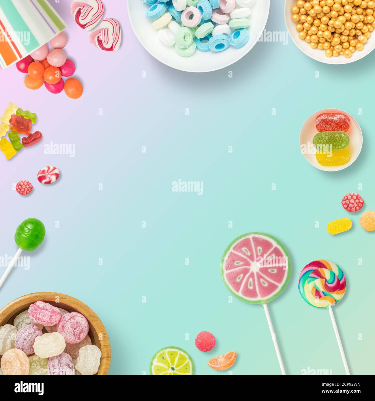 Candies, chocolates and lollipops on a light blue background with copy ...