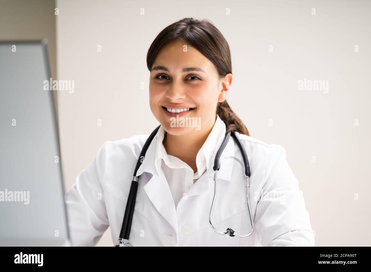 Happy Physician Doctor Woman At Computer Desk Stock Photo - Alamy