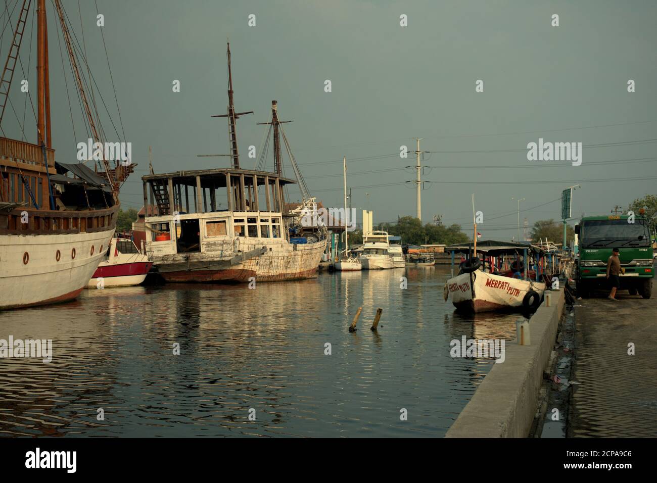 Old canal and phinisi ships at the area of Port of Tanjung Emas Port in ...