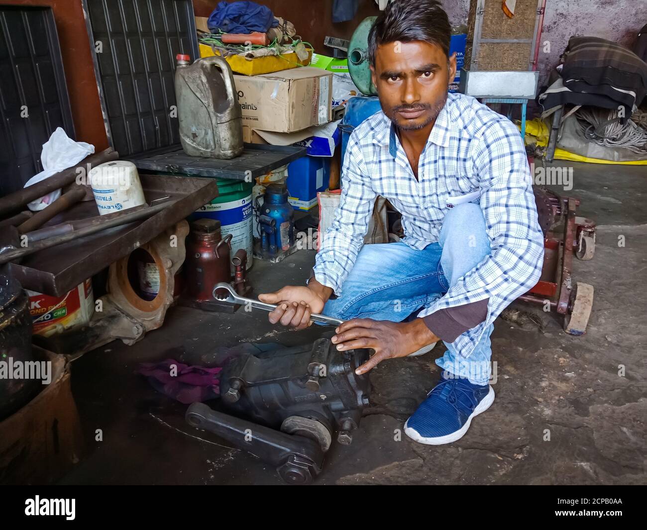 DISTRICT KATNI, INDIA - DECEMBER 09, 2019: An indian mechanic repairing ...