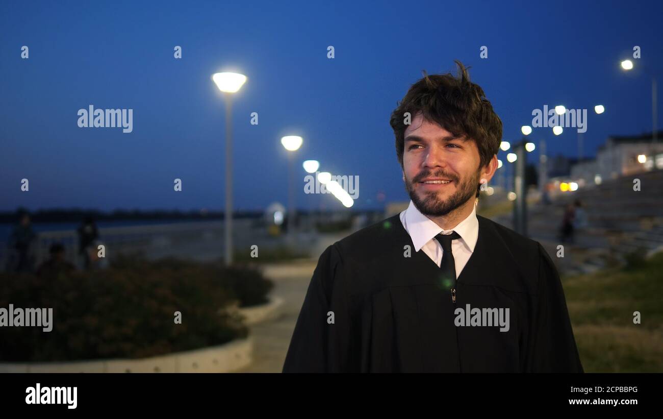 Man walking after the graduation ceremony Stock Photo - Alamy