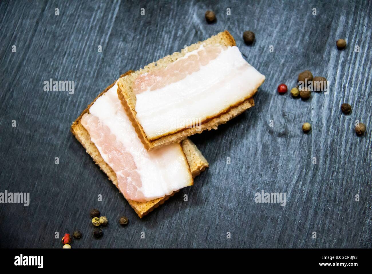 Sliced pieces of bacon lays on the bread. Ukrainian traditional meal ...