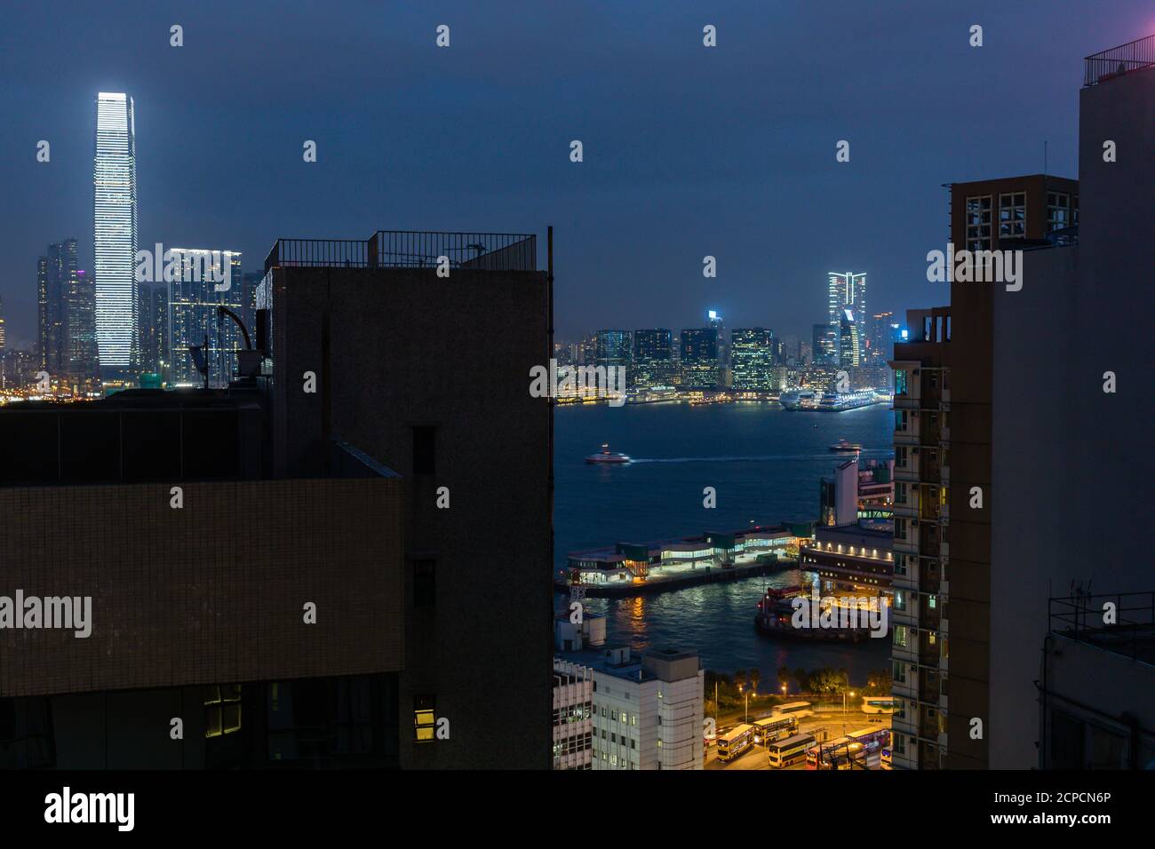 Victoria Harbor and Hong Kong Macau Ferry at night Stock Photo - Alamy