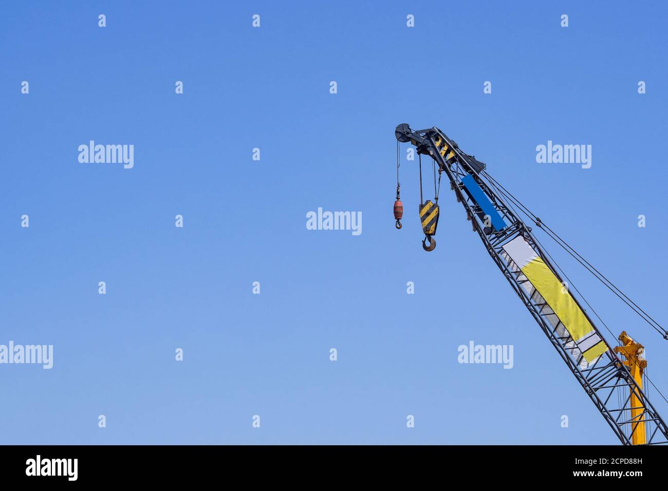 Construction site with cranes on sky background. Big blue machinery ...