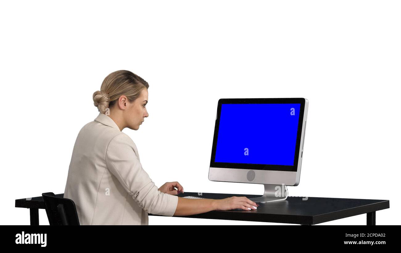 Business person works at table with computer, white background Stock ...