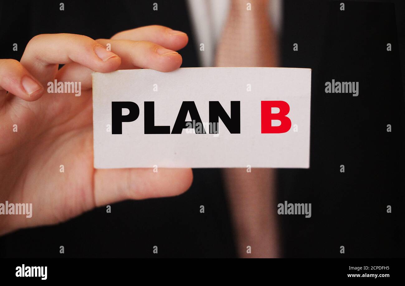 Plan B words on card in hand of businessman wearing suit and tie ...