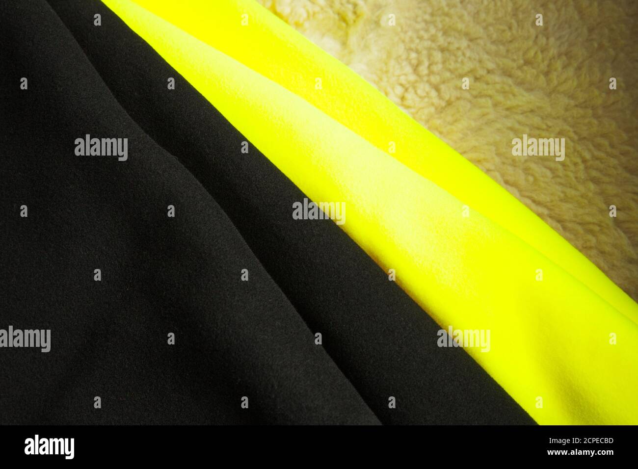 Background texture of yellow abd black fleece, soft napped insulating ...
