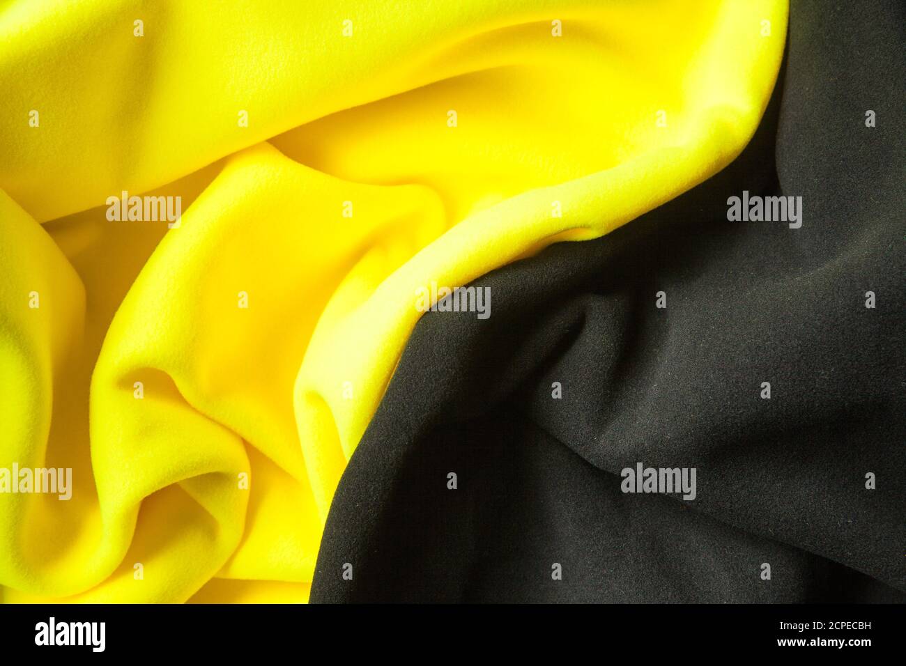 Background texture of yellow and black fleece, soft napped insulating ...