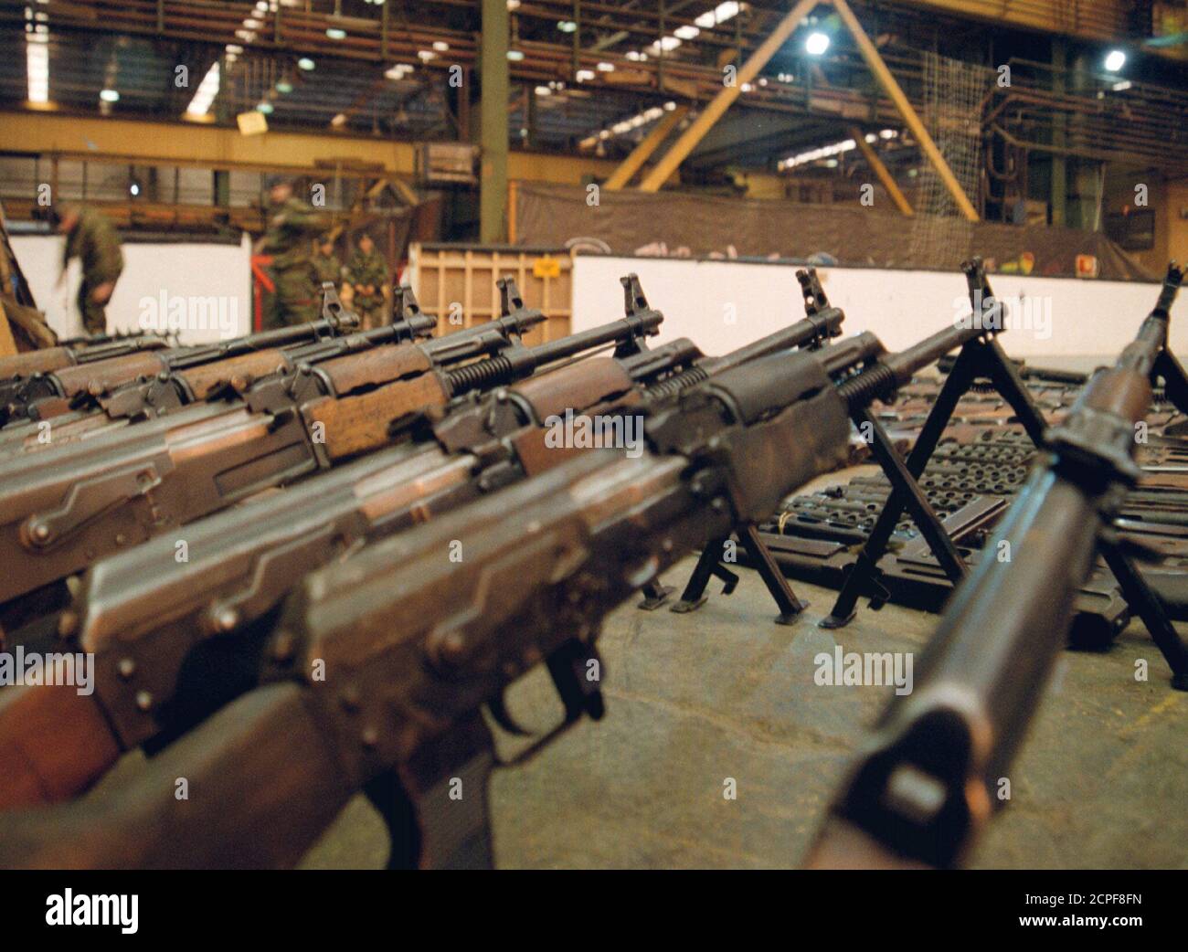 British soldiers walk among weapons collected in post-war Bosnia ...