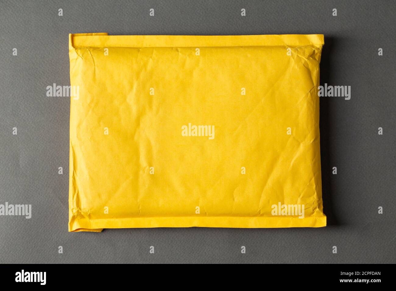 Yellow paper bag on a gray background. Packaging for international ...