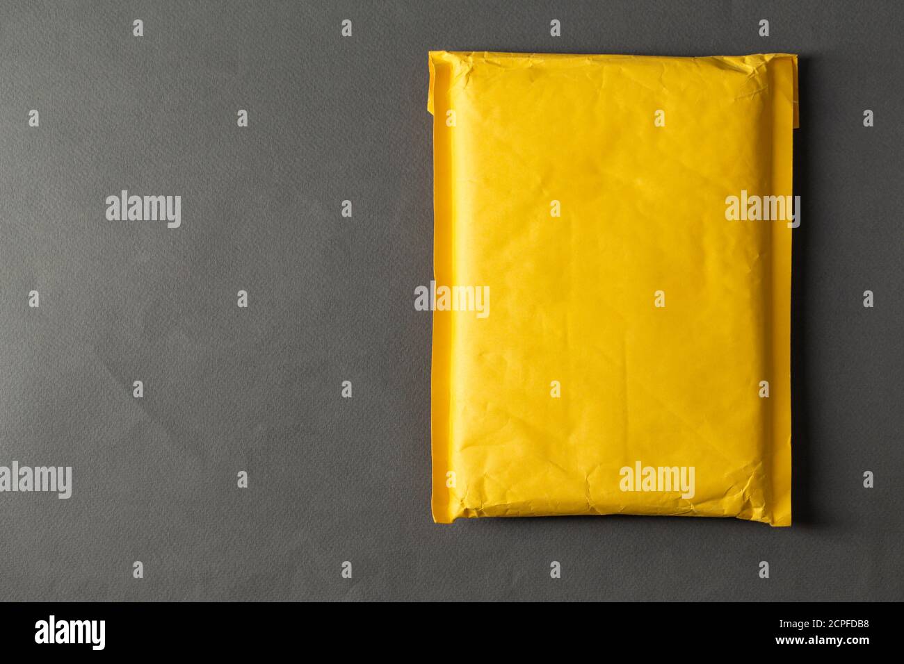 Yellow paper bag on a gray background. Packaging for international ...