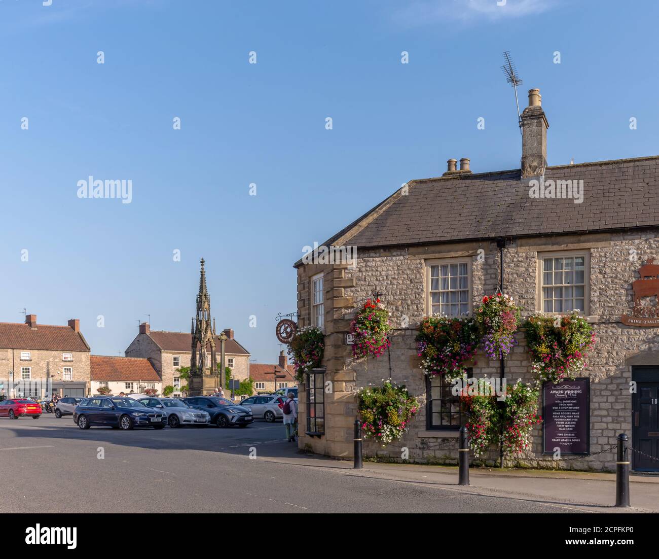 A market town centre. A public house stands on the corner of the town ...