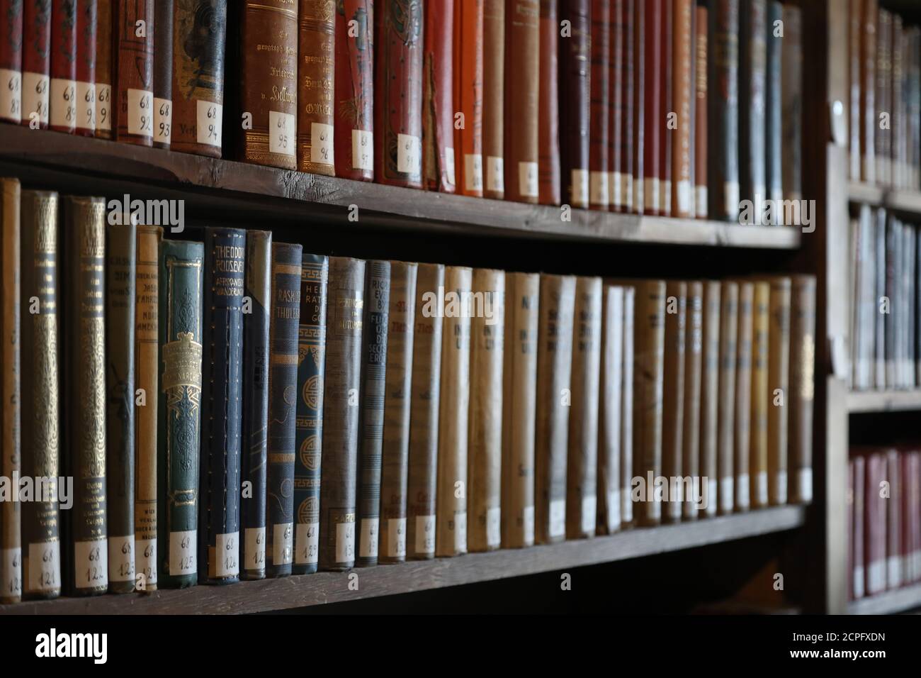 Ancient books on a bookshelf Stock Photo - Alamy