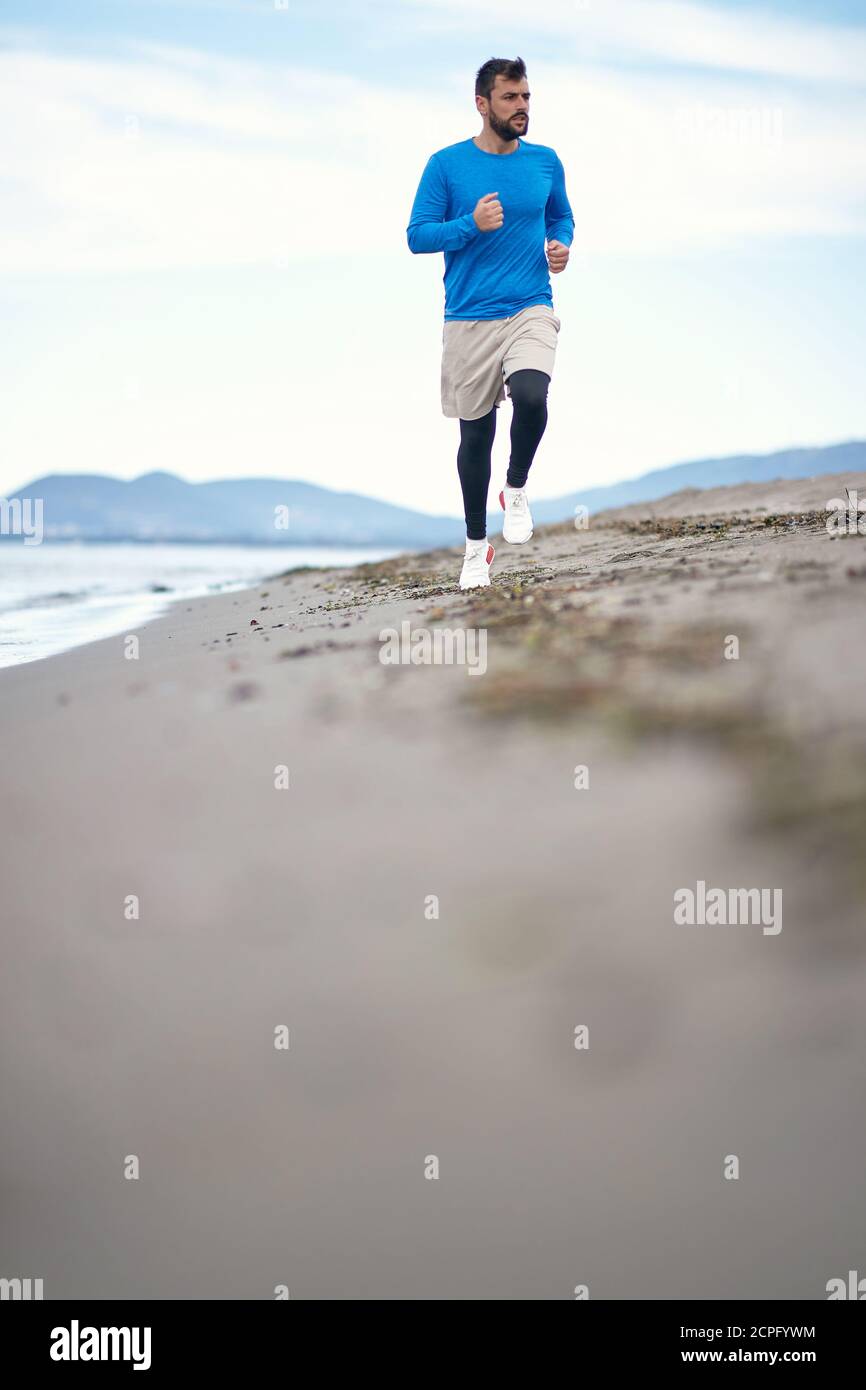 Man running beach handsome hi-res stock photography and images - Alamy