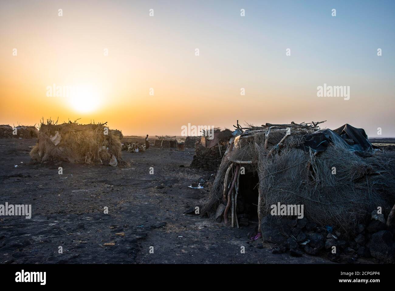 Village with huts of the Afar nomads at sunset, Danakil Depression ...