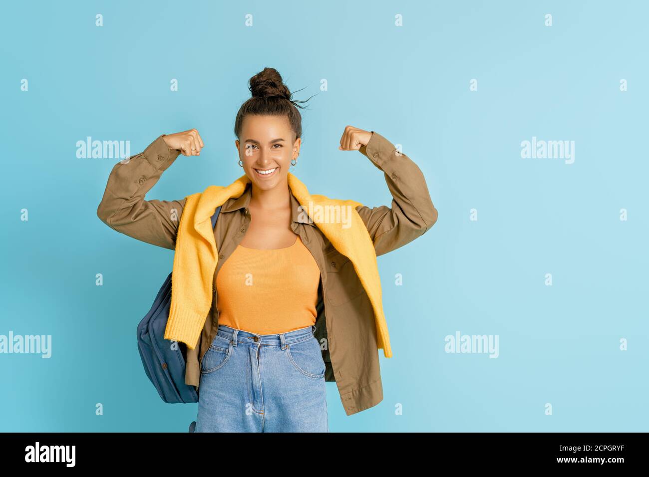 Happy emotional young woman posing and laughing on bright blue ...