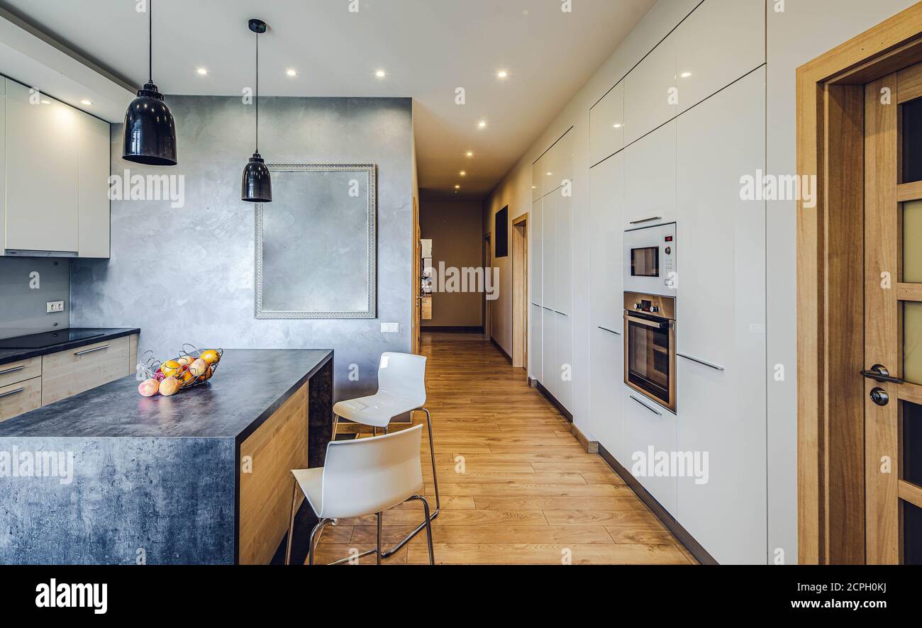 Contemporary interior of kitchen in luxury flat. Wooden kitchen table ...
