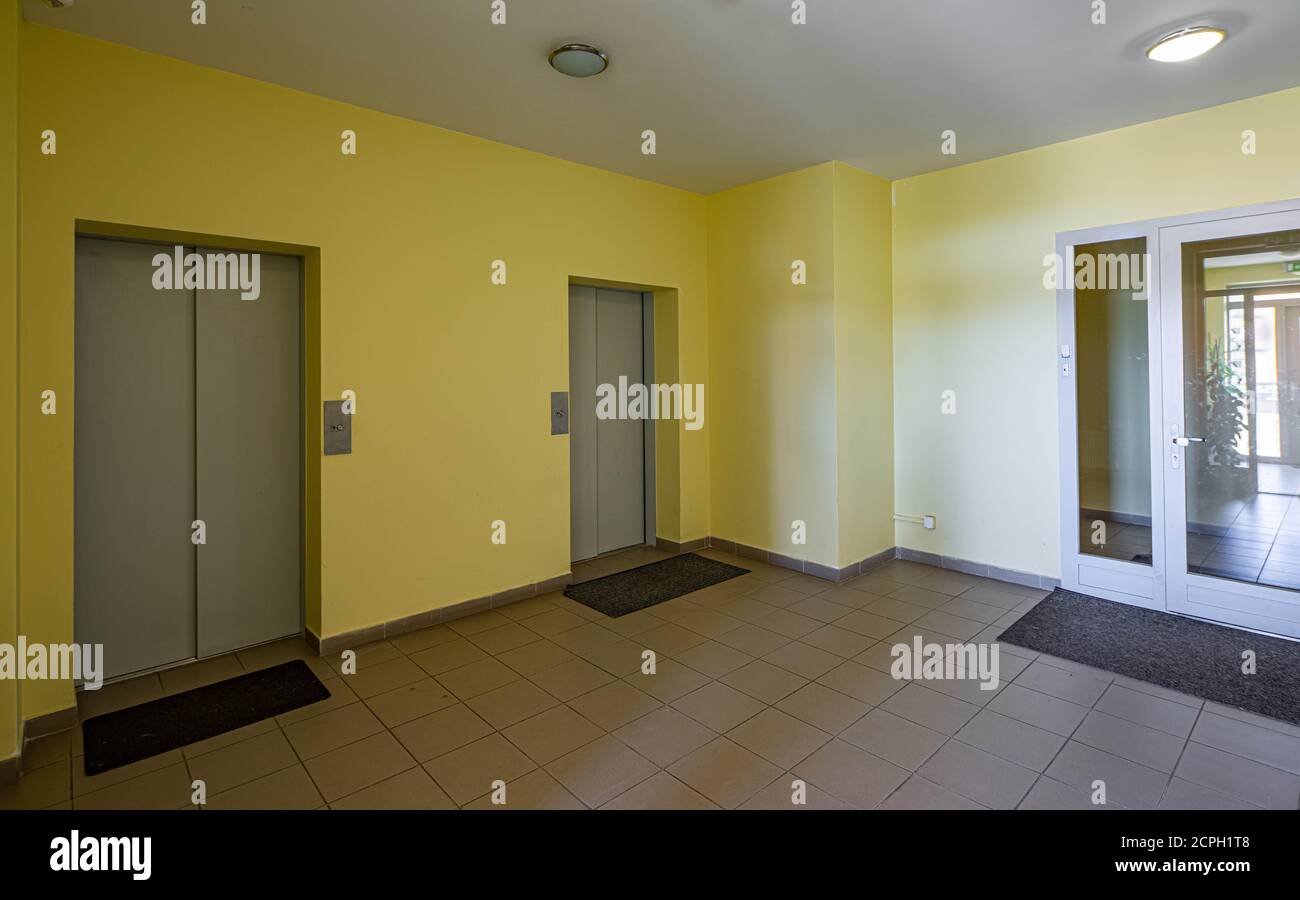 Modern interior of entrance in residential buildings. Glass dor ...