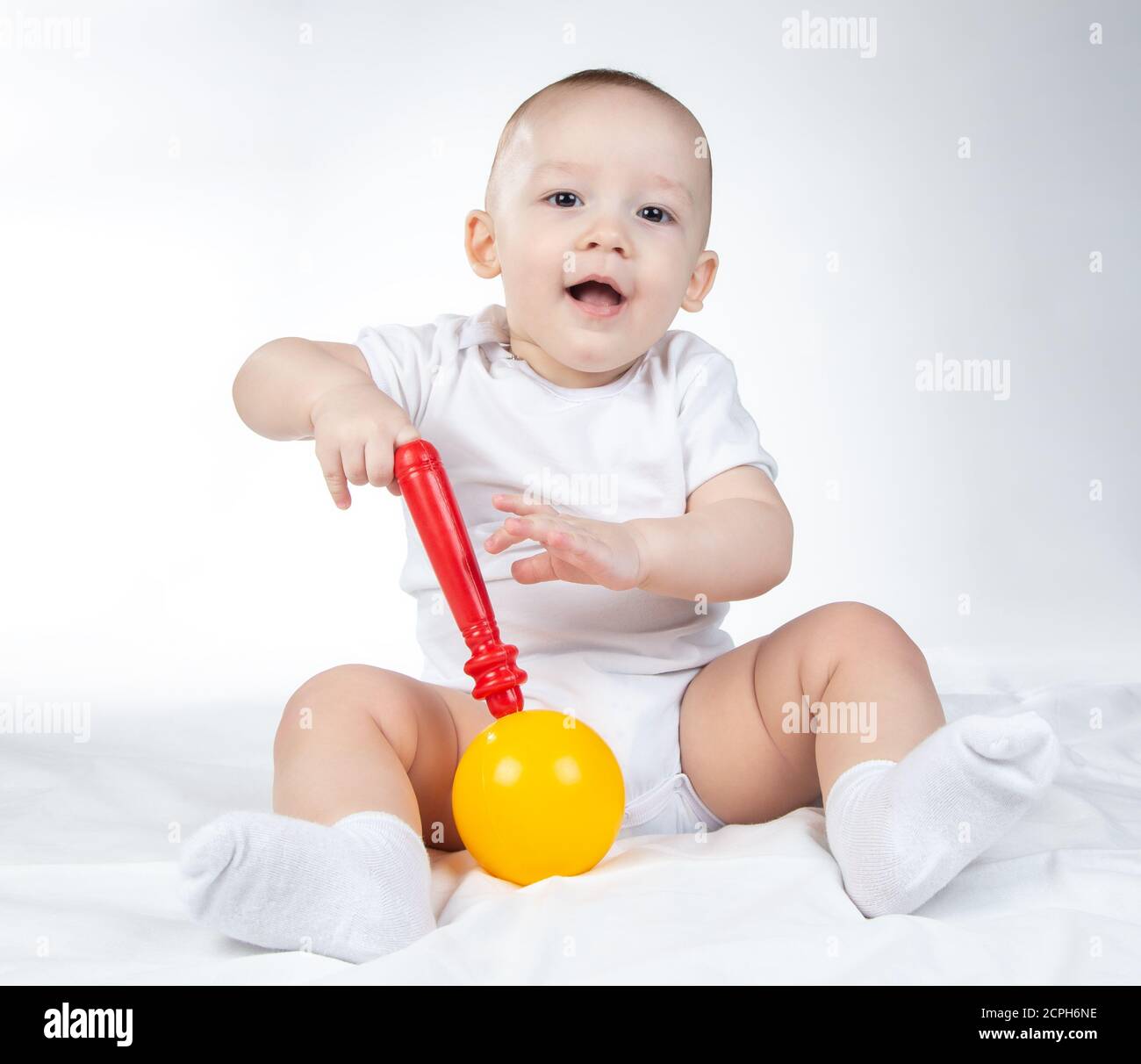 Photo of a eleven-month-old baby with rattle Stock Photo - Alamy