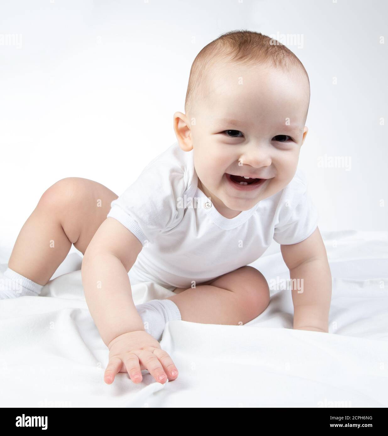 Photo of crawling eleven-month-old baby on a white background Stock ...