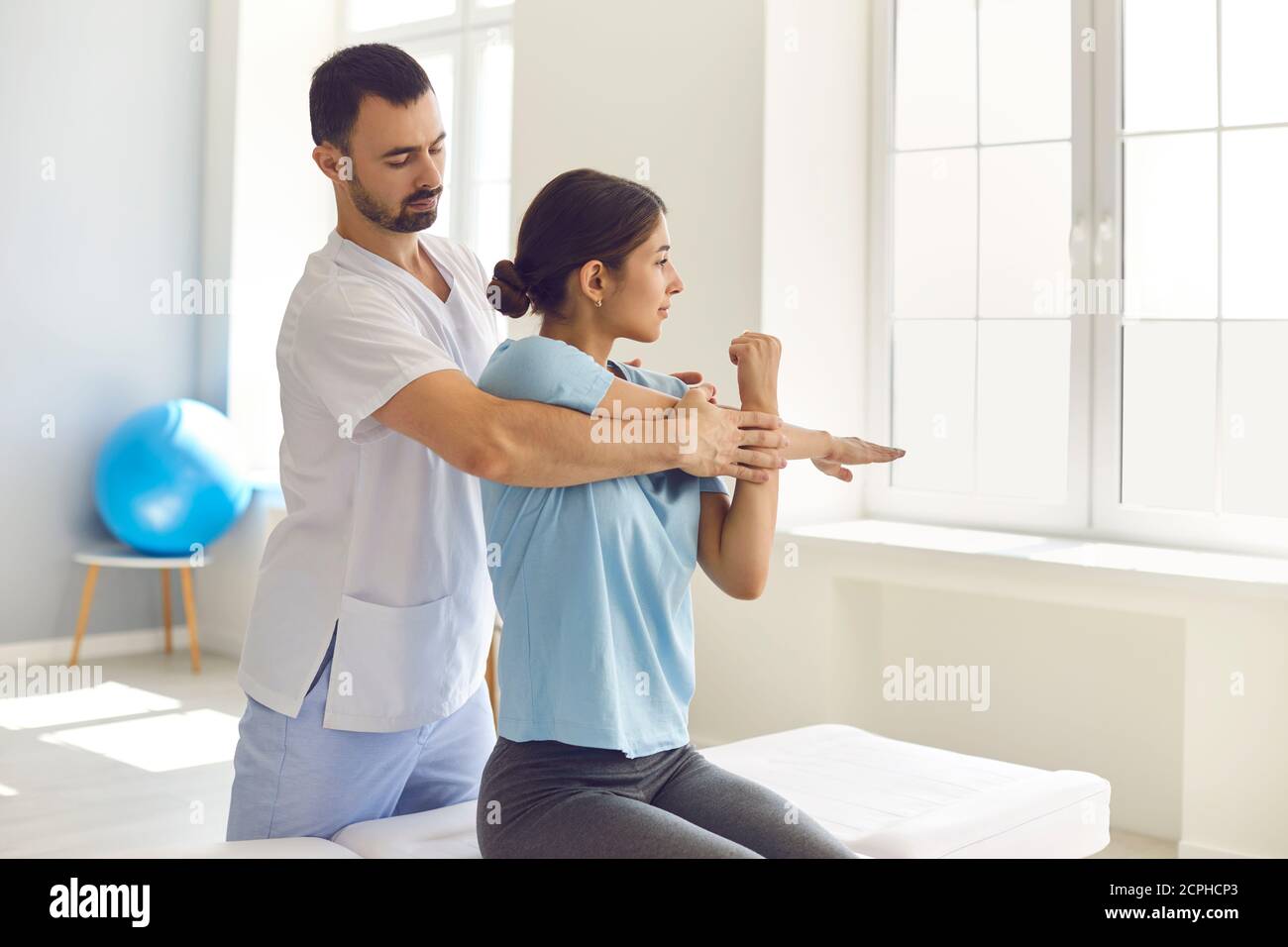 Physiotherapist and patient working on arm injury, doing medical ...