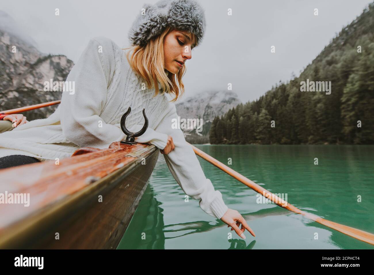 Beautiful woman visiting an alpine lake at Braies, Italy - Tourist with ...
