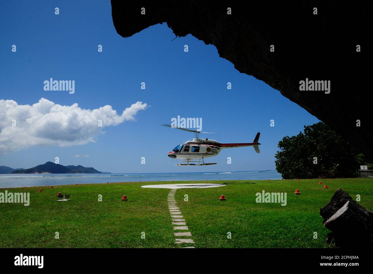 Helicopter landing on a helipad on a tropical island Stock Photo - Alamy