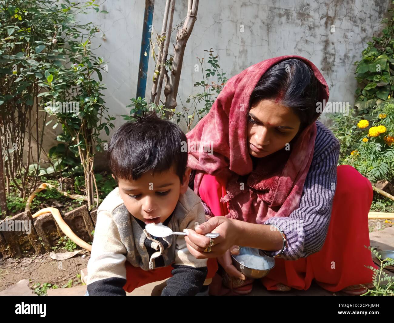 DISTRICT KATNI, INDIA - JANUARY 15, 2020: Indian village poor mother ...