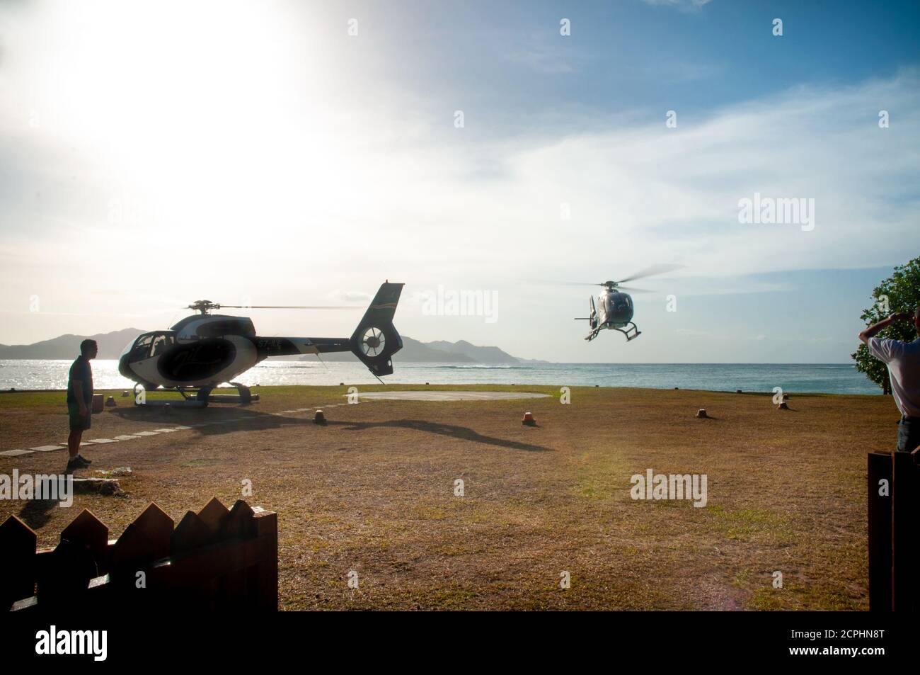 Helicopter landing on a helipad on a tropical island Stock Photo - Alamy