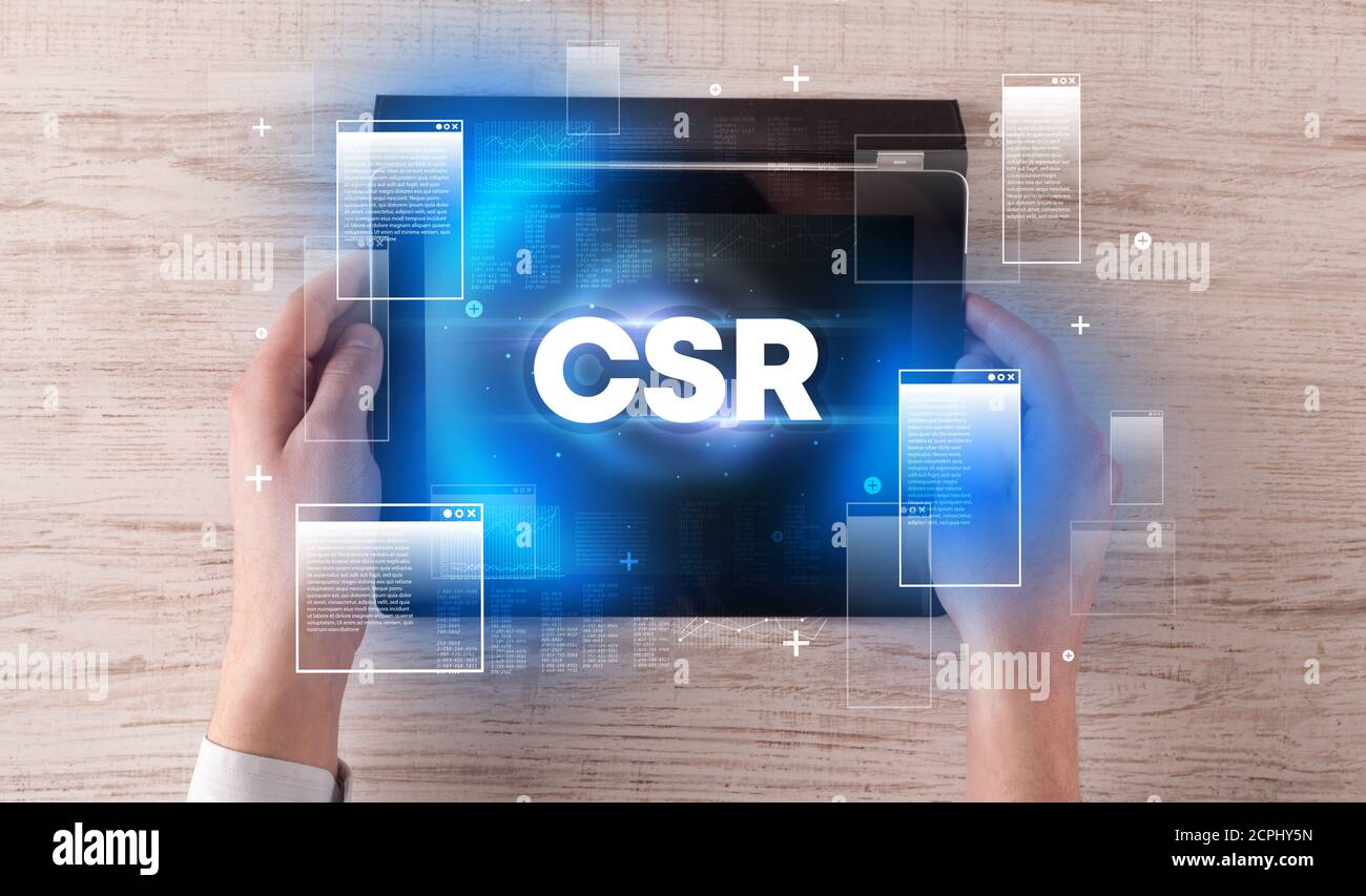 Close-up of a hand holding tablet with CSR abbreviation, modern ...
