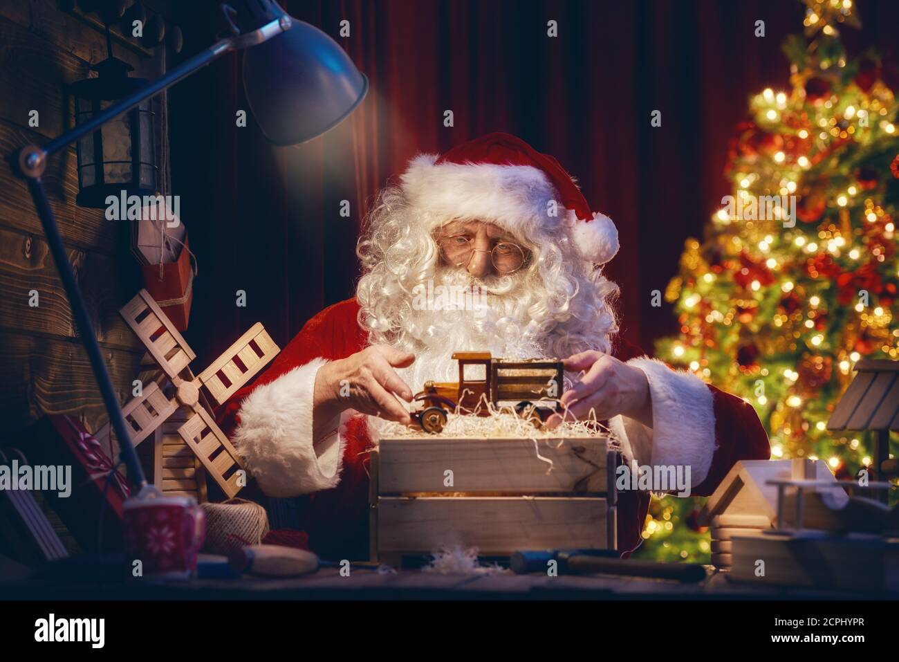 Merry Christmas and Happy Holidays! Santa Clause is preparing gifts for ...