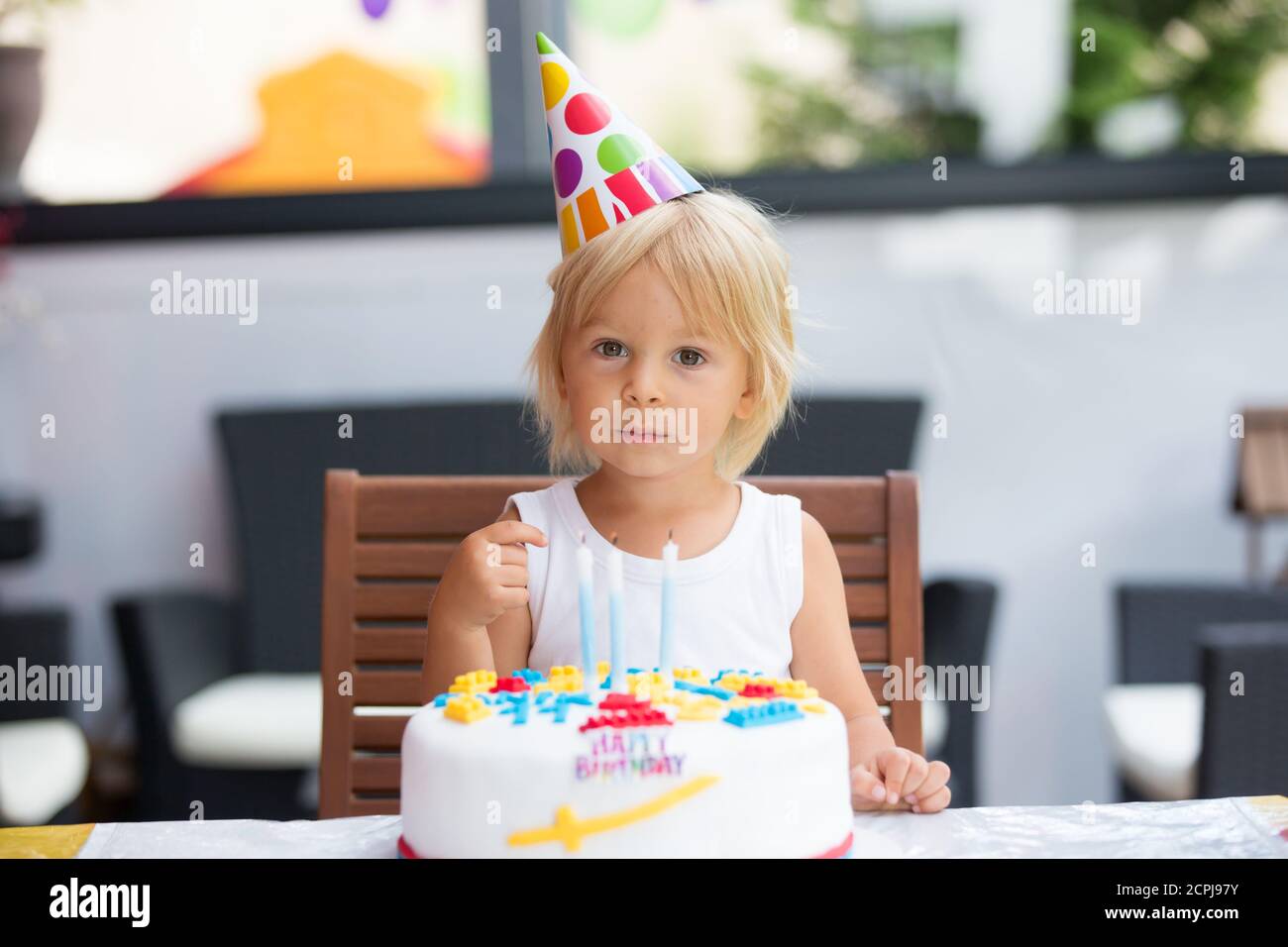 Adorable happy child, little kid boy celebrating his birthday at home ...
