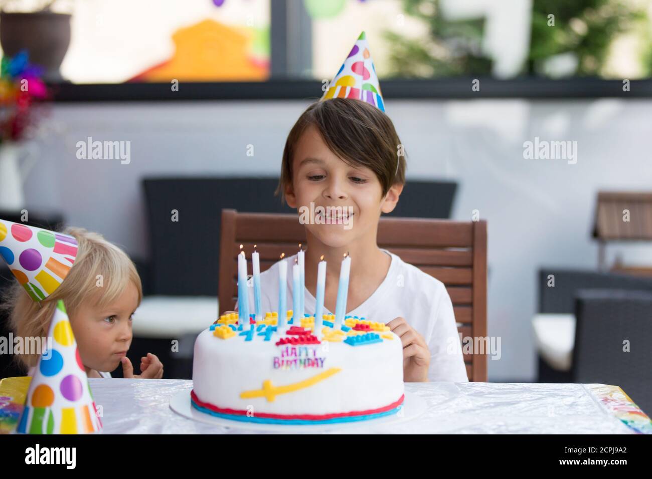Adorable happy child, little kid boy celebrating his birthday at home ...