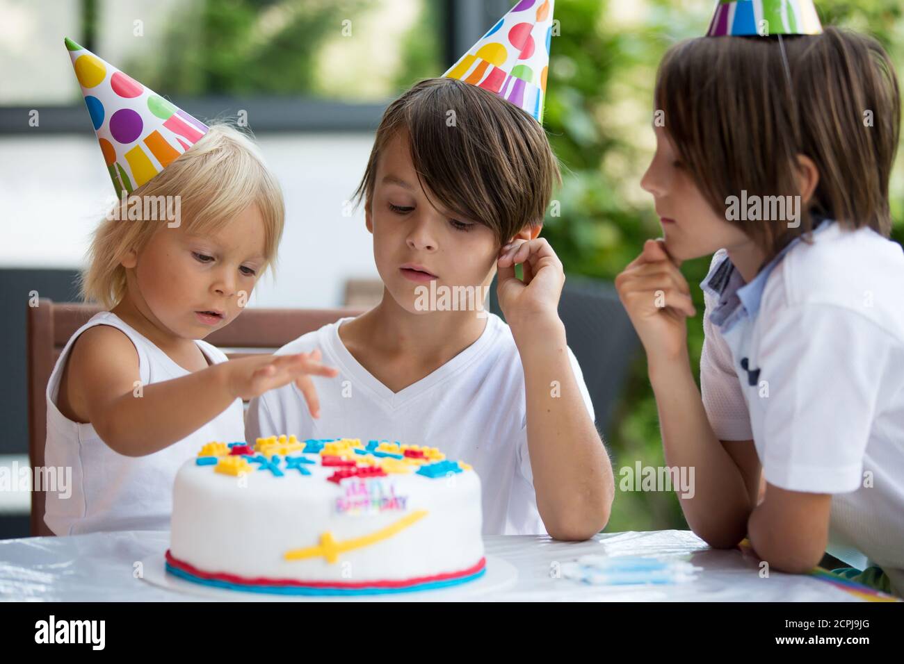 Adorable happy child, little kid boy celebrating his birthday at home ...