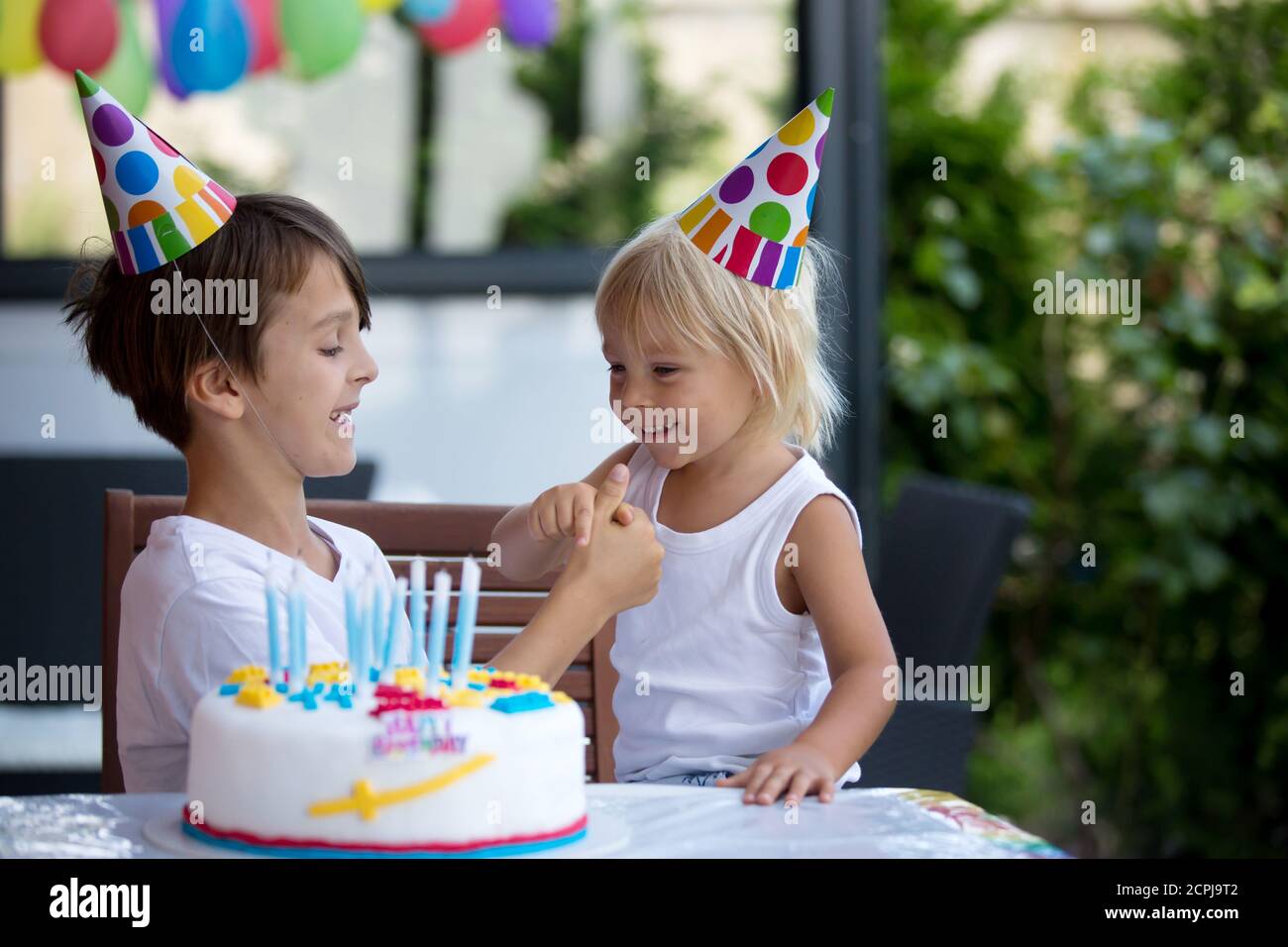 Adorable happy child, little kid boy celebrating his birthday at home ...