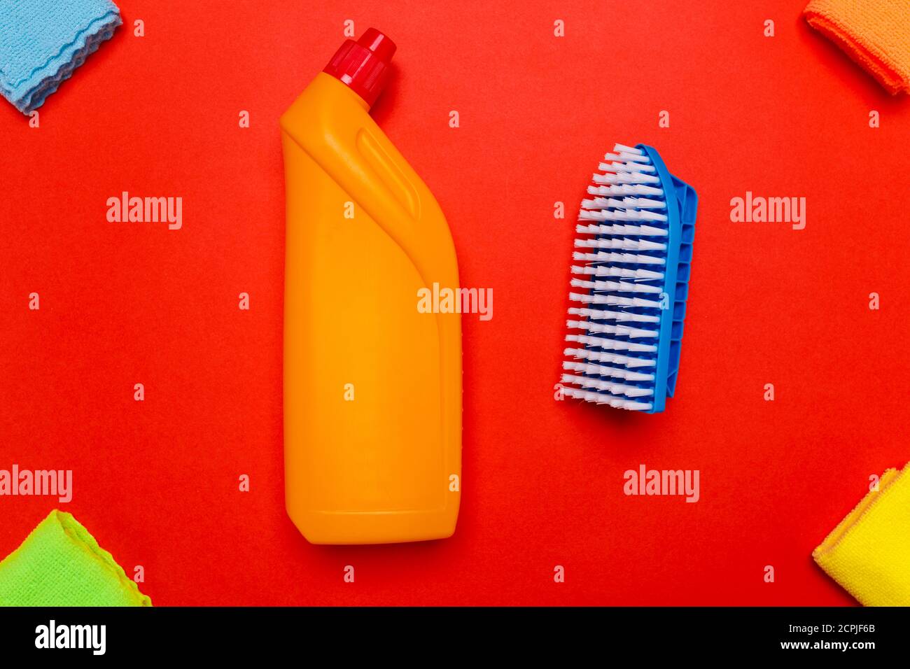 yellow cleaner with a brush on a red background Stock Photo - Alamy