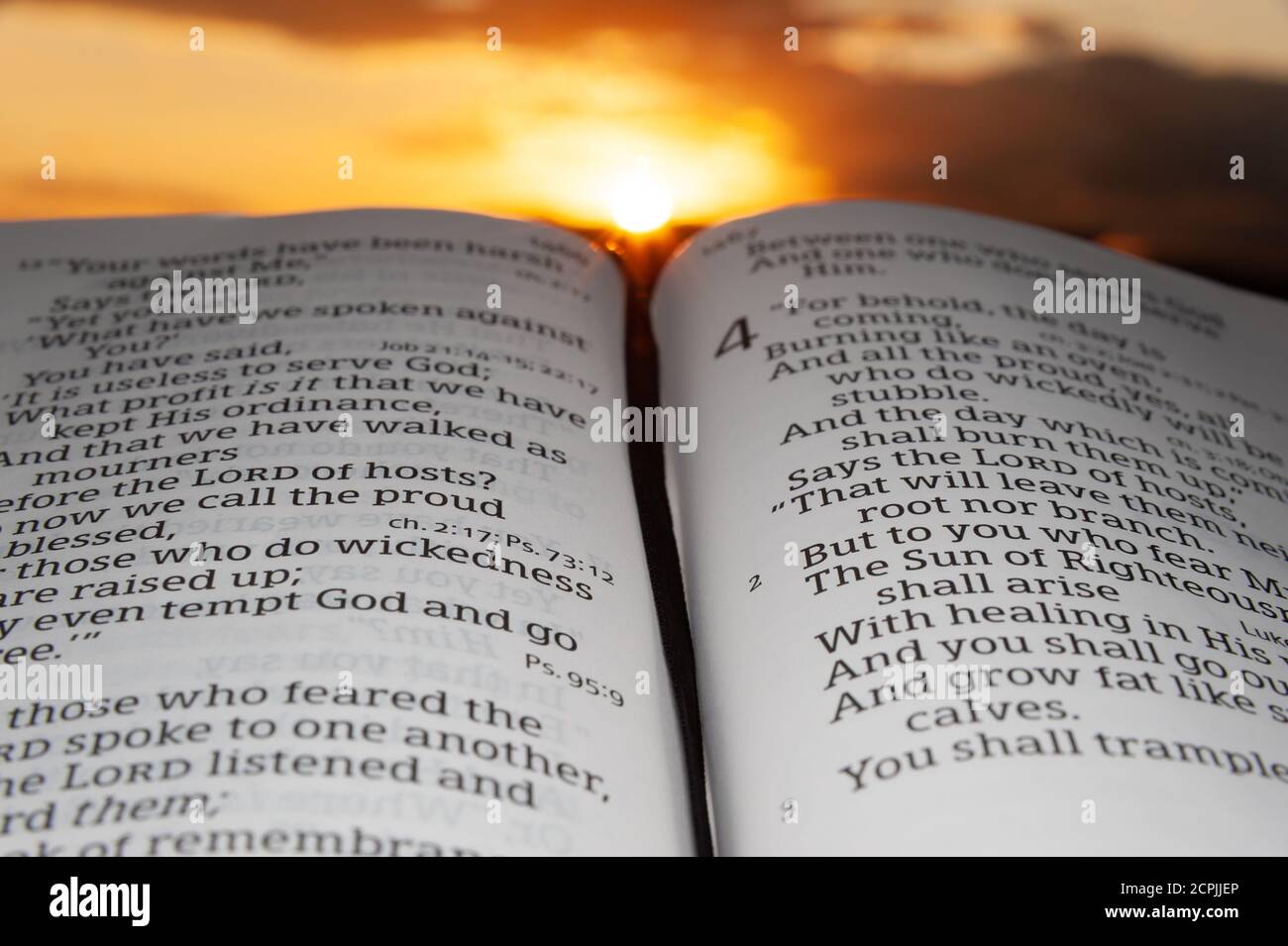 Holy Bible opened at sunset, highlighted in Malachi chapter 4 verse 2 ...