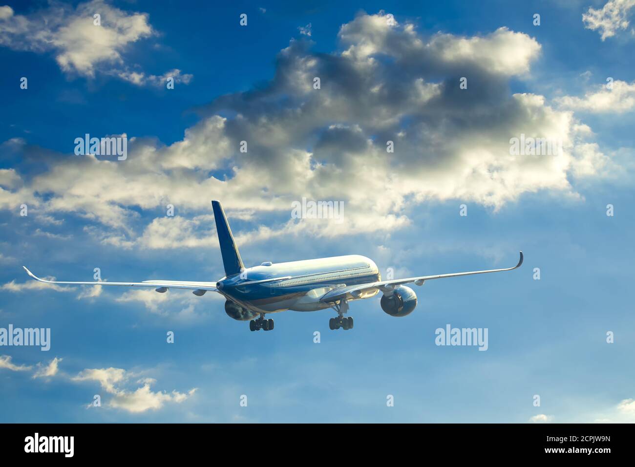 Big airplane fly to blue sky after taking off at sunset.Travel ...